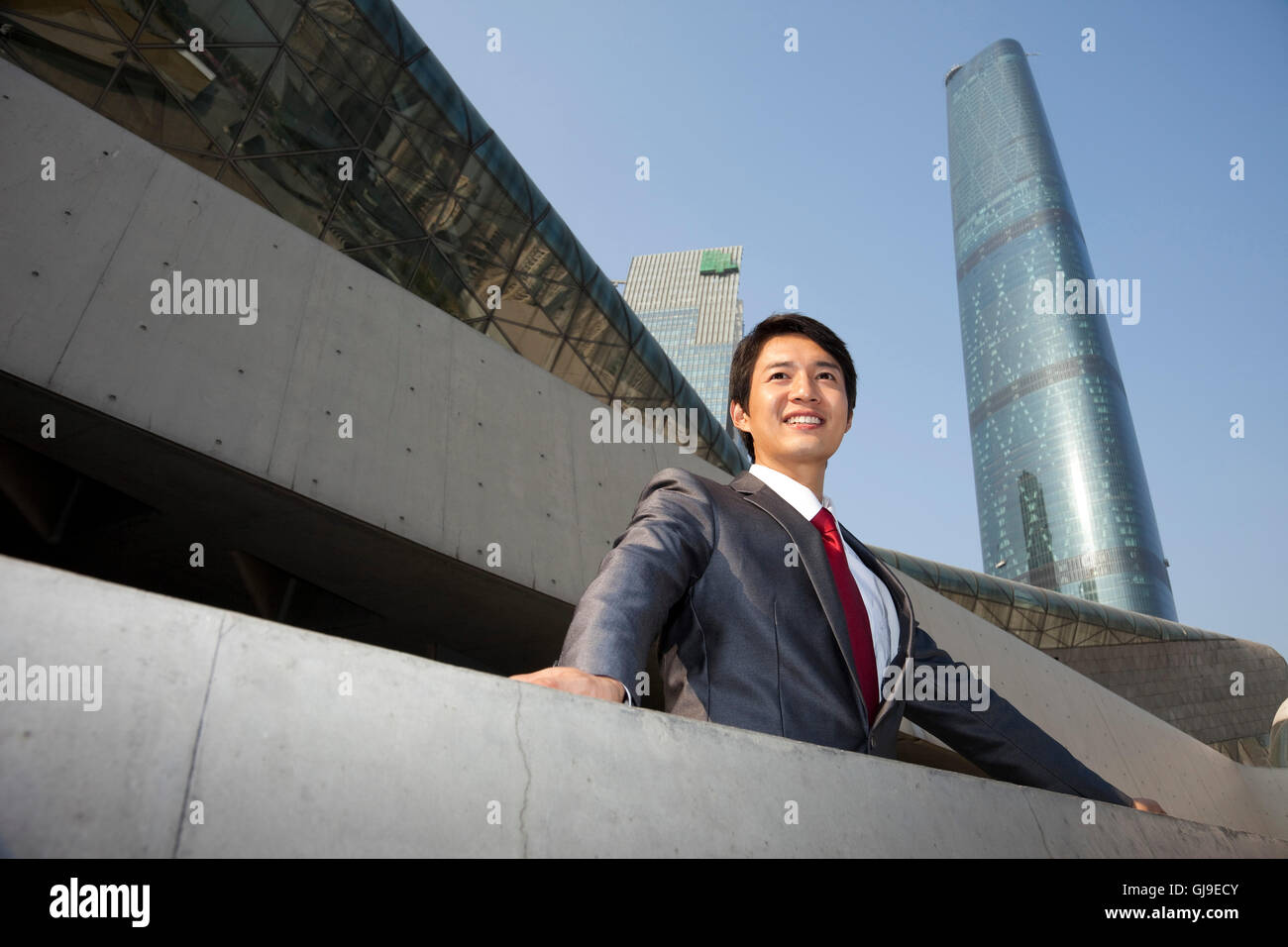 Young business man outside office building Stock Photo - Alamy