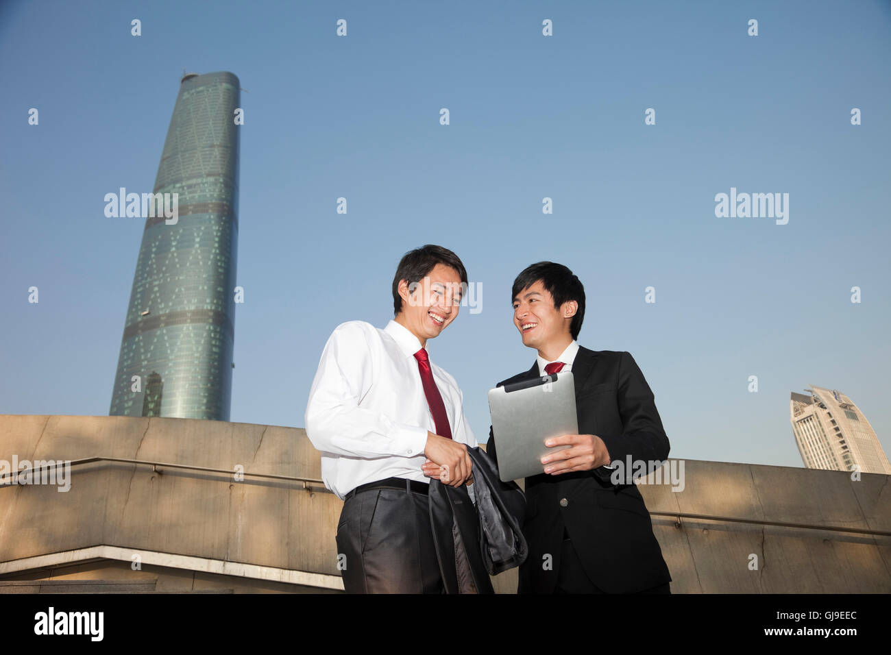 Young business man outside office building Stock Photo - Alamy