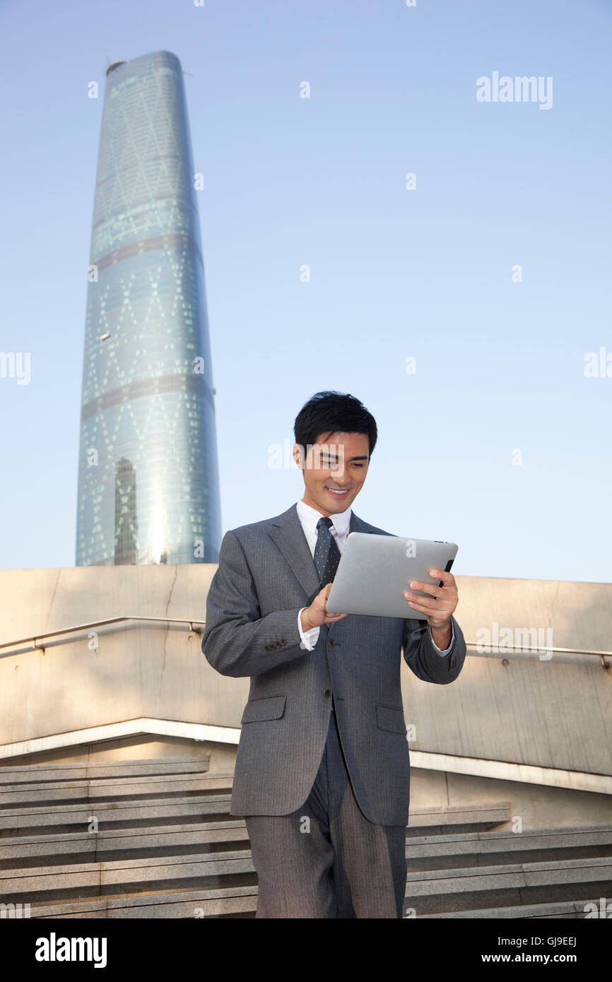 Young business man outside office building Stock Photo - Alamy