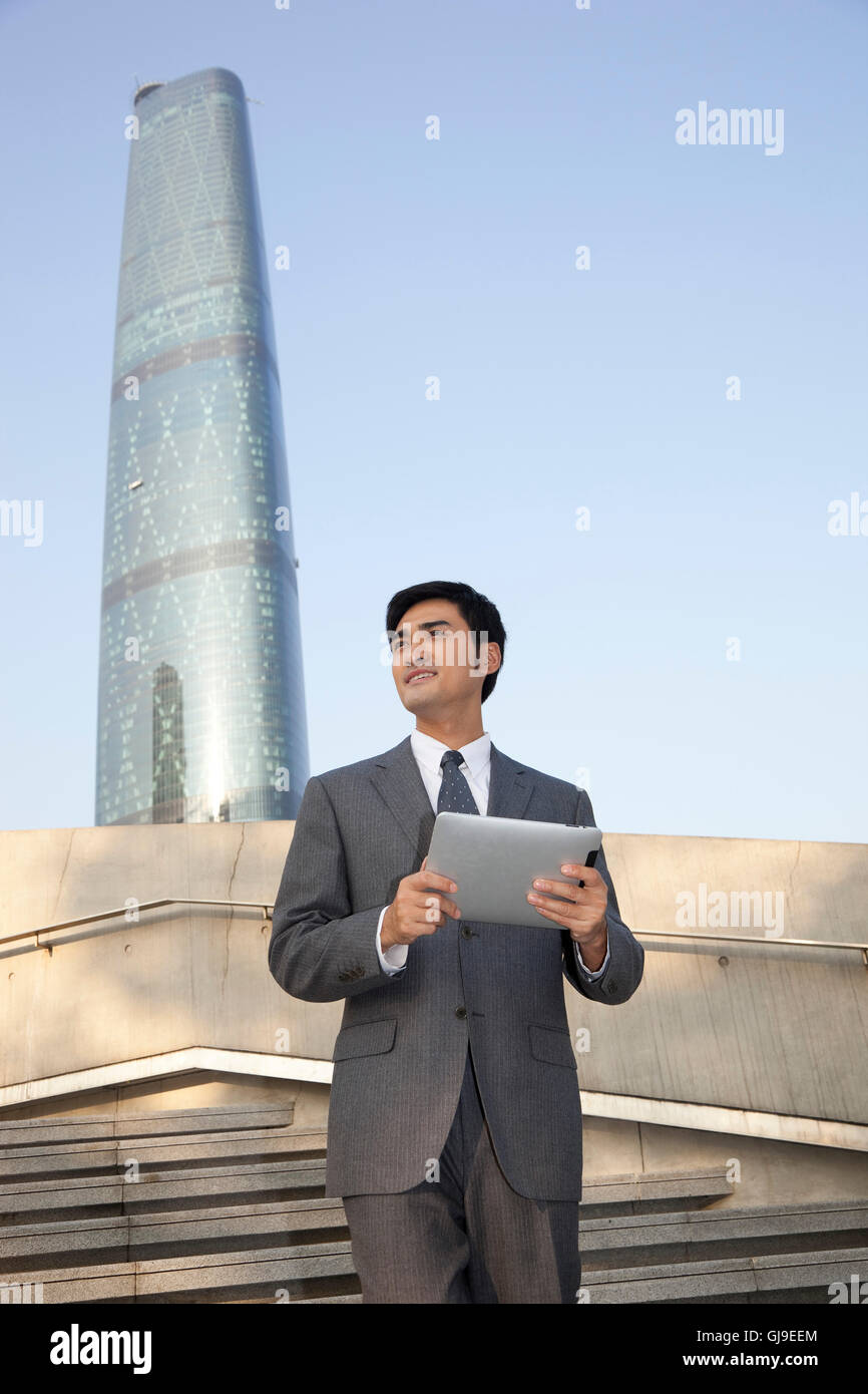 Young business man outside office building Stock Photo - Alamy