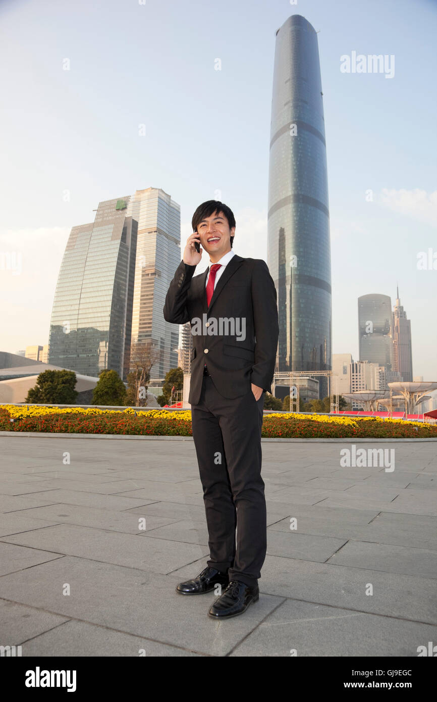Young business man outside office building Stock Photo - Alamy