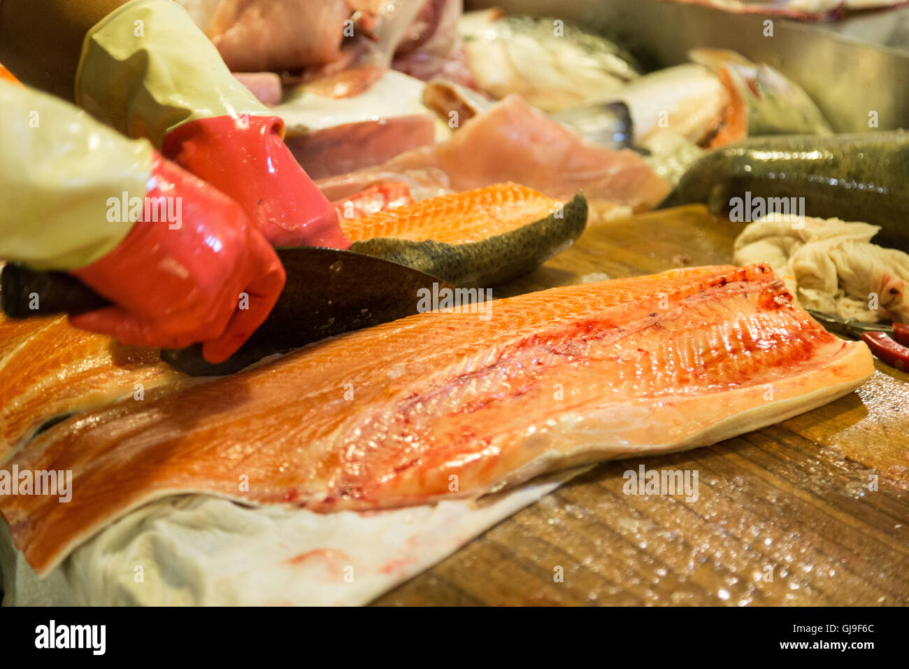 Large fish being cut at fishmongers Stock Photo - Alamy