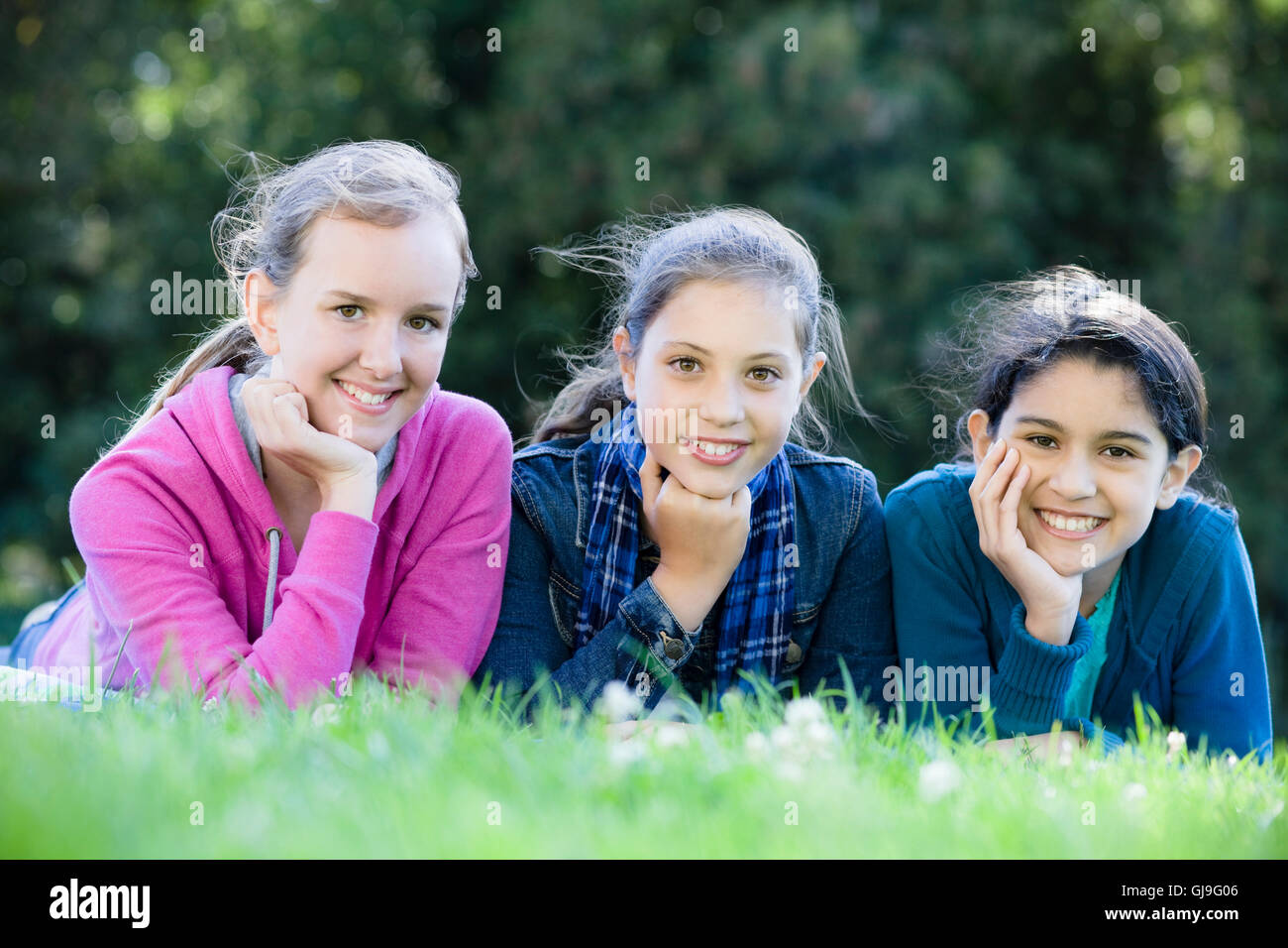 Group Of Tween Girls Lying On Grass Stock Photo - Alamy