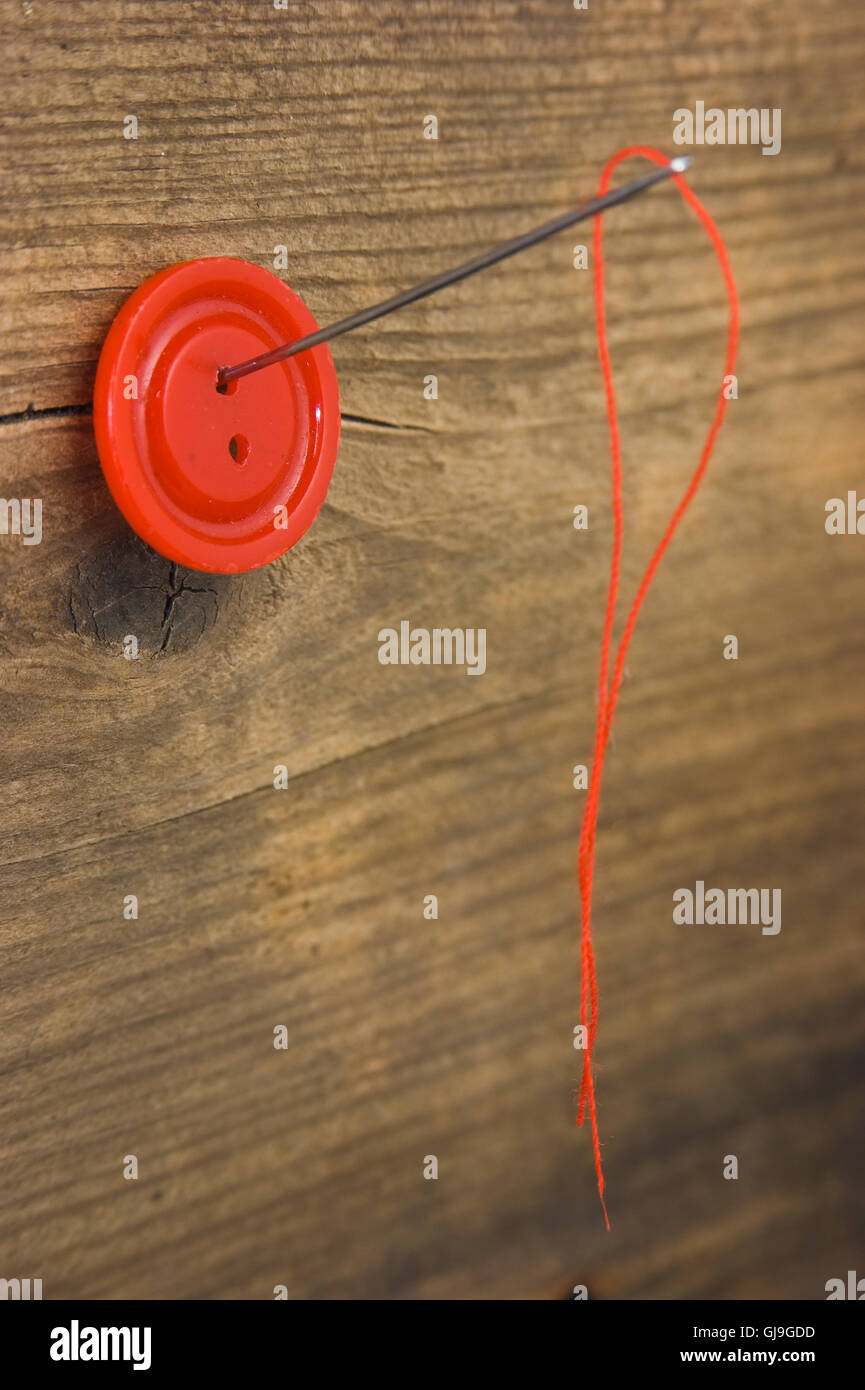 Buttons with needle and thread Stock Photo - Alamy