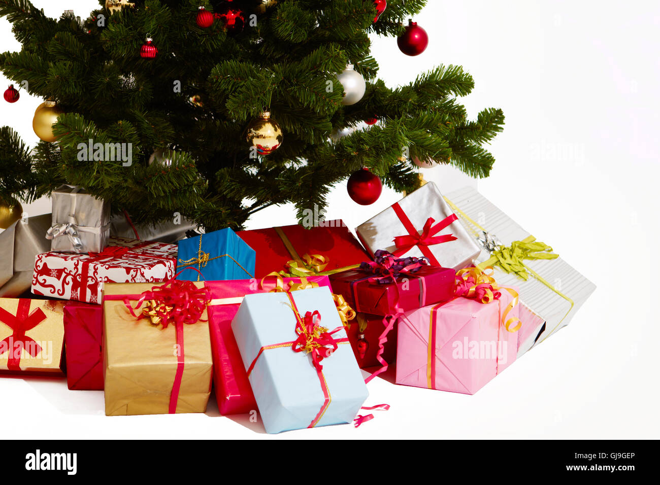 Christmas - Presents under a tree on white Stock Photo - Alamy