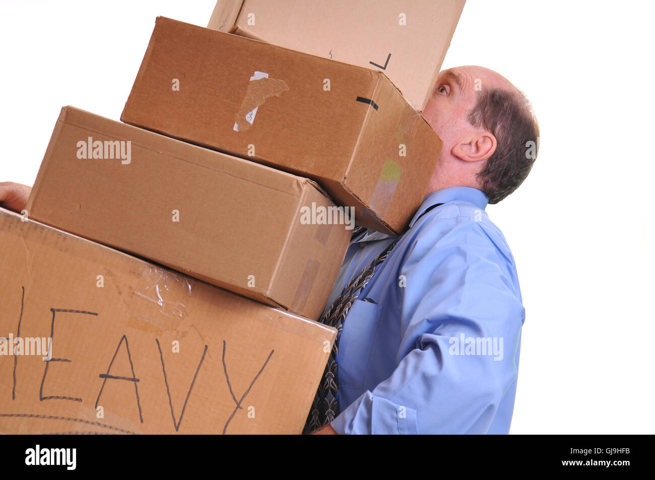 Man carrying heavy boxes Stock Photo - Alamy