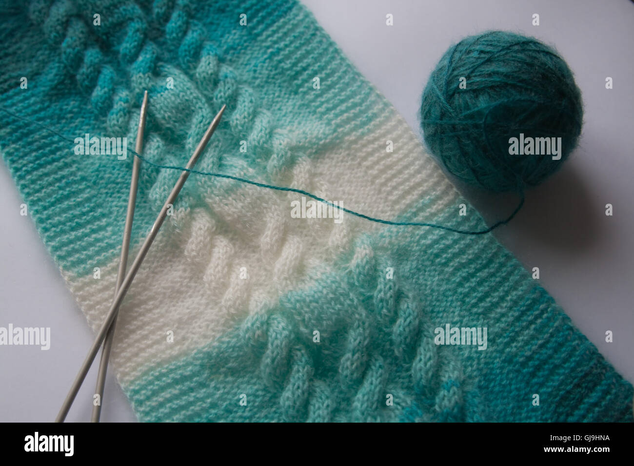 Unfinished Knitted white and blue scarf Stock Photo - Alamy