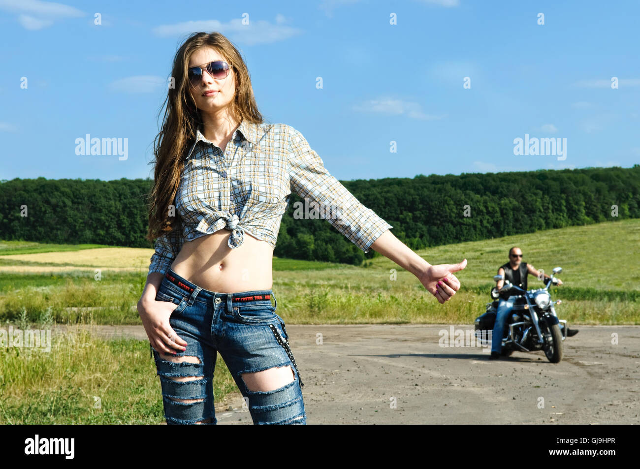 Girl hitchhicker on the road Stock Photo - Alamy