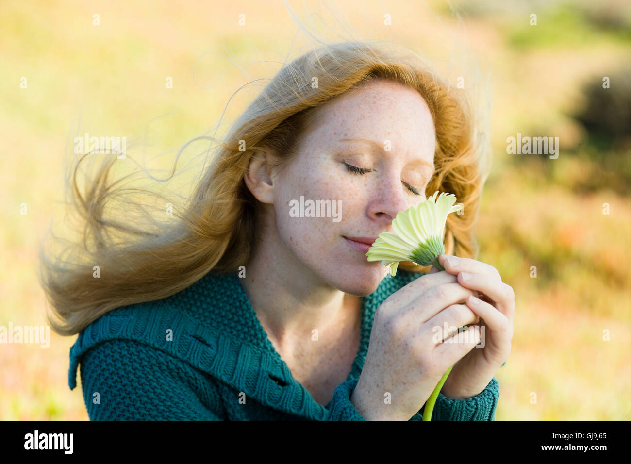 Woman Smelling Flower Stock Photo - Alamy