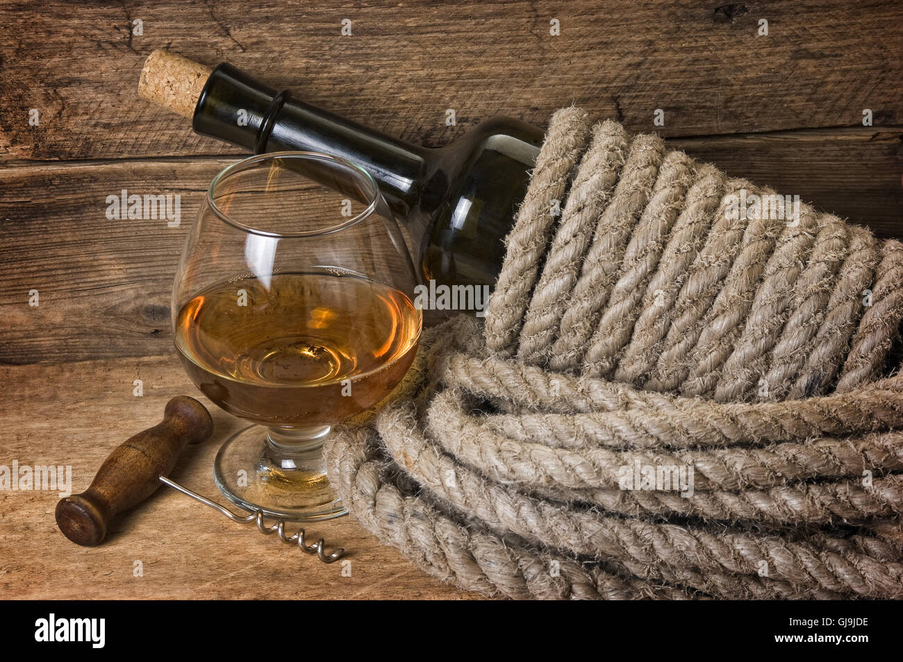 bottle of wine wrapped with rope Stock Photo - Alamy