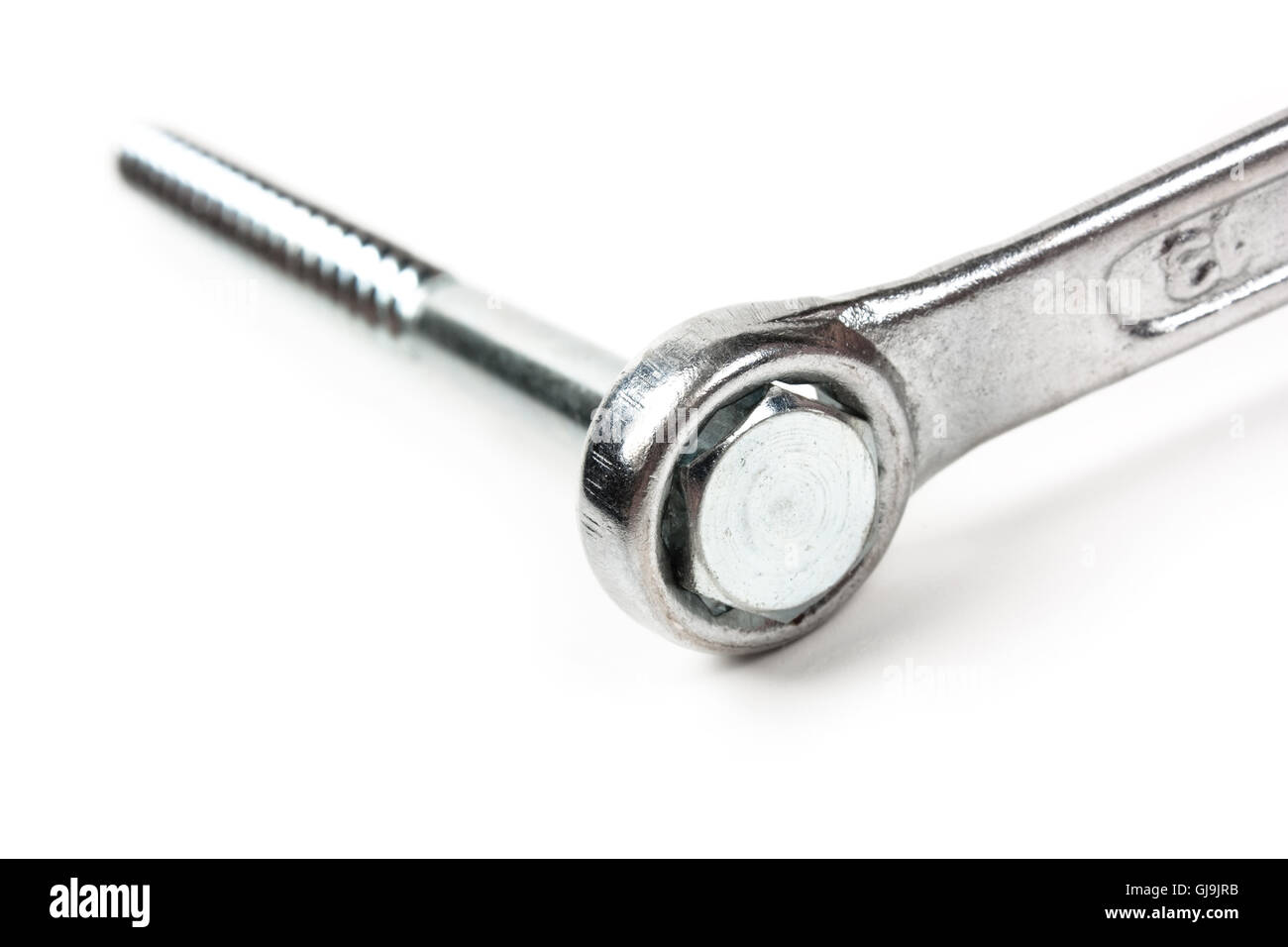 screw with a wrench Stock Photo - Alamy