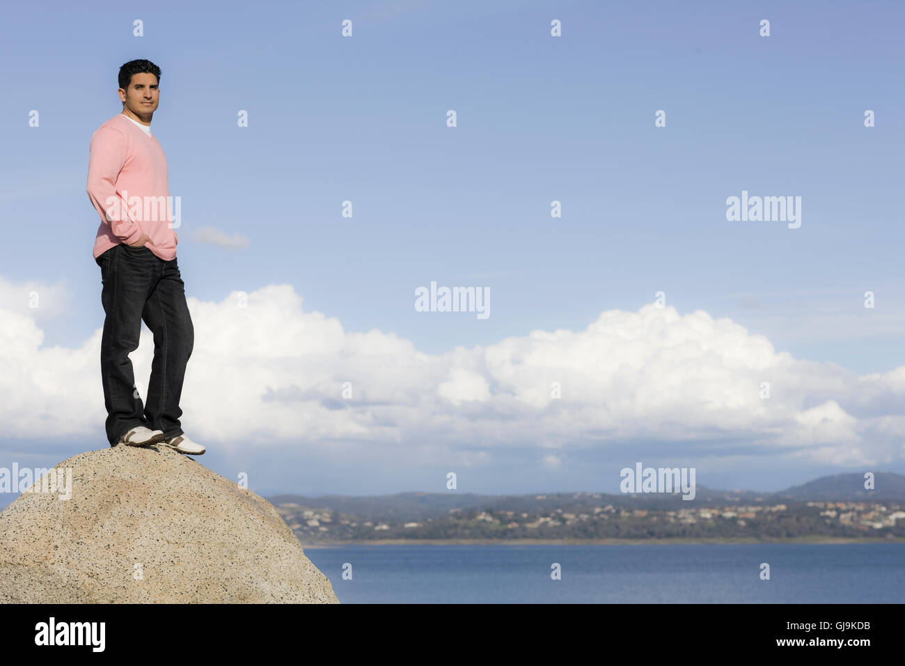 Portrait of Man Standing on Rock Stock Photo - Alamy