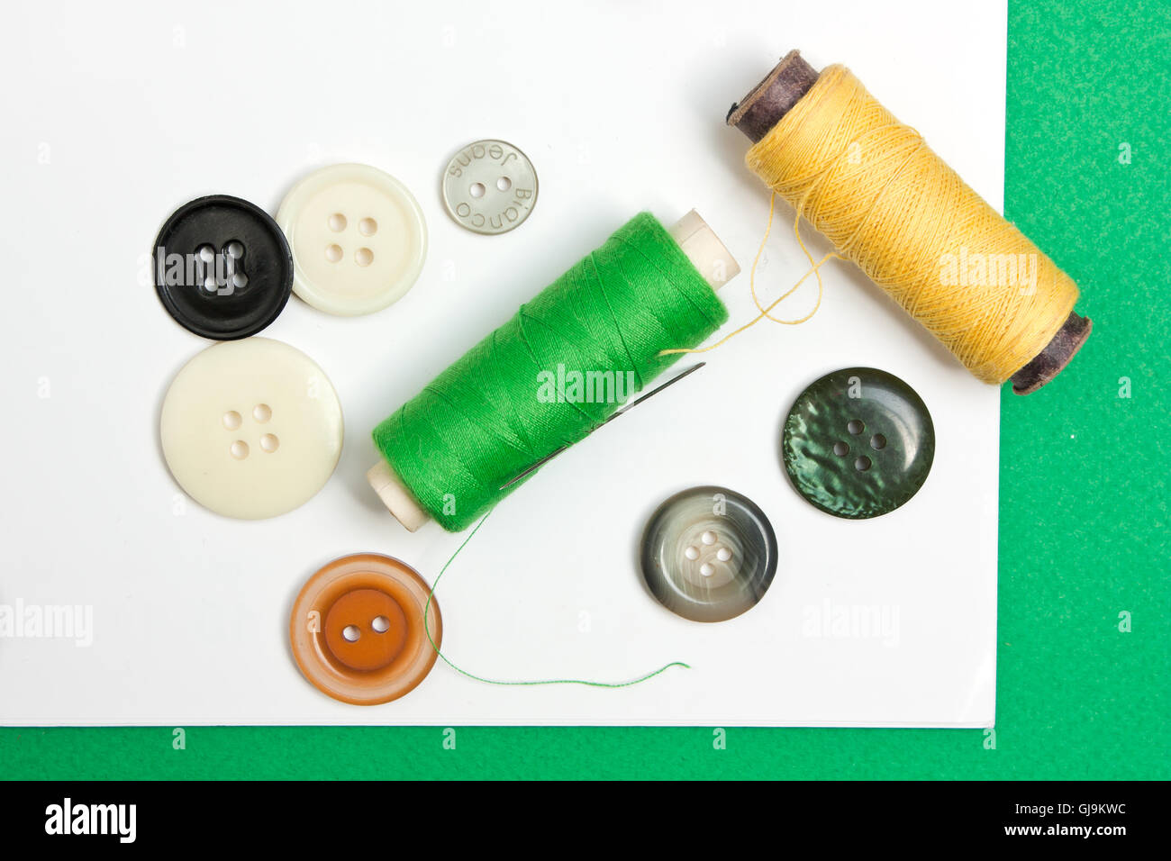 thread with a needle and buttons Stock Photo - Alamy