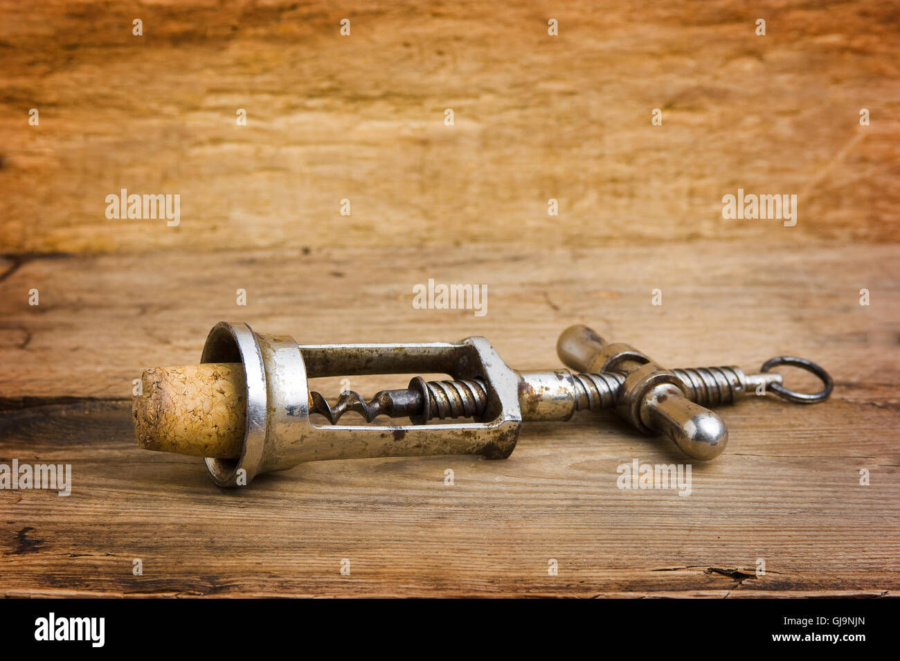 old corkscrew with a cork Stock Photo - Alamy