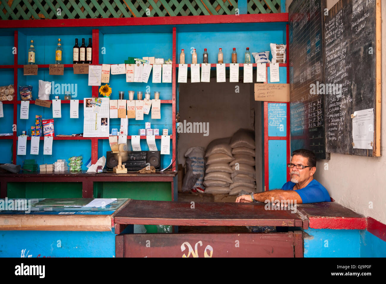 A merchant and his small store that sells grocery type items in the ...
