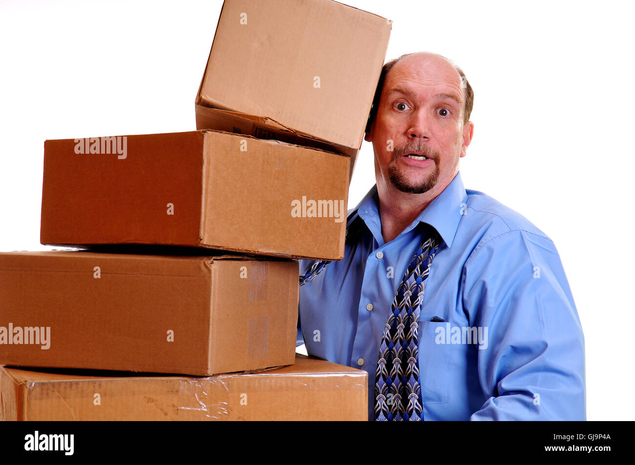 Man carrying heavy boxes Stock Photo - Alamy