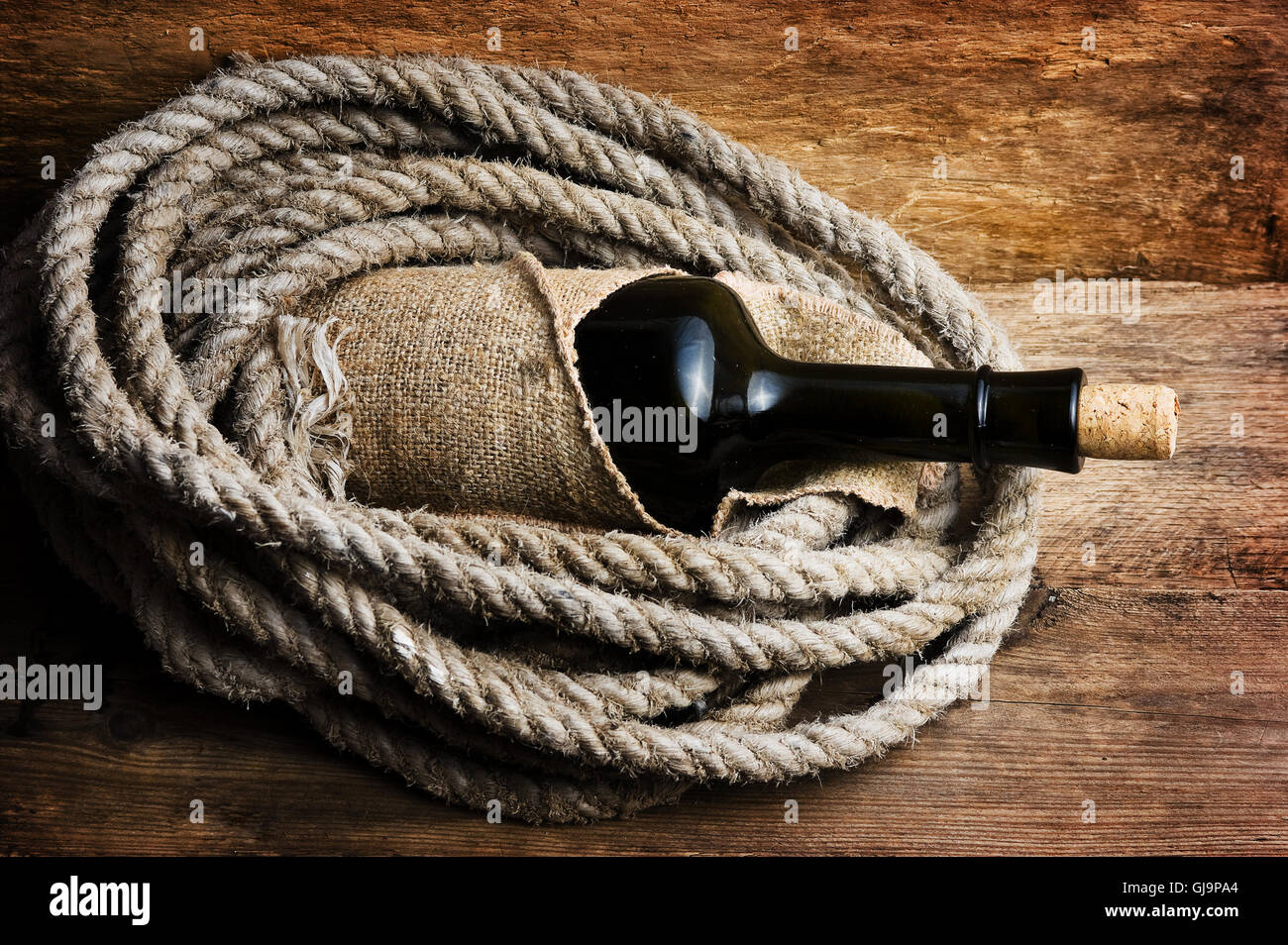 bottle wrapped with rope Stock Photo - Alamy