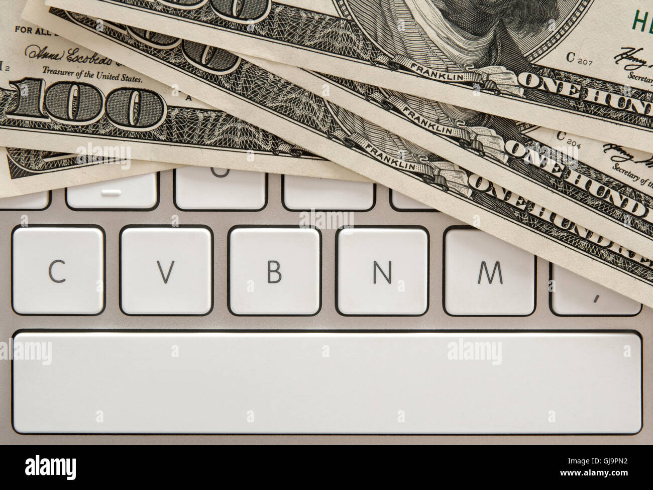 Money bills on computer keyboard with spacebar Stock Photo - Alamy