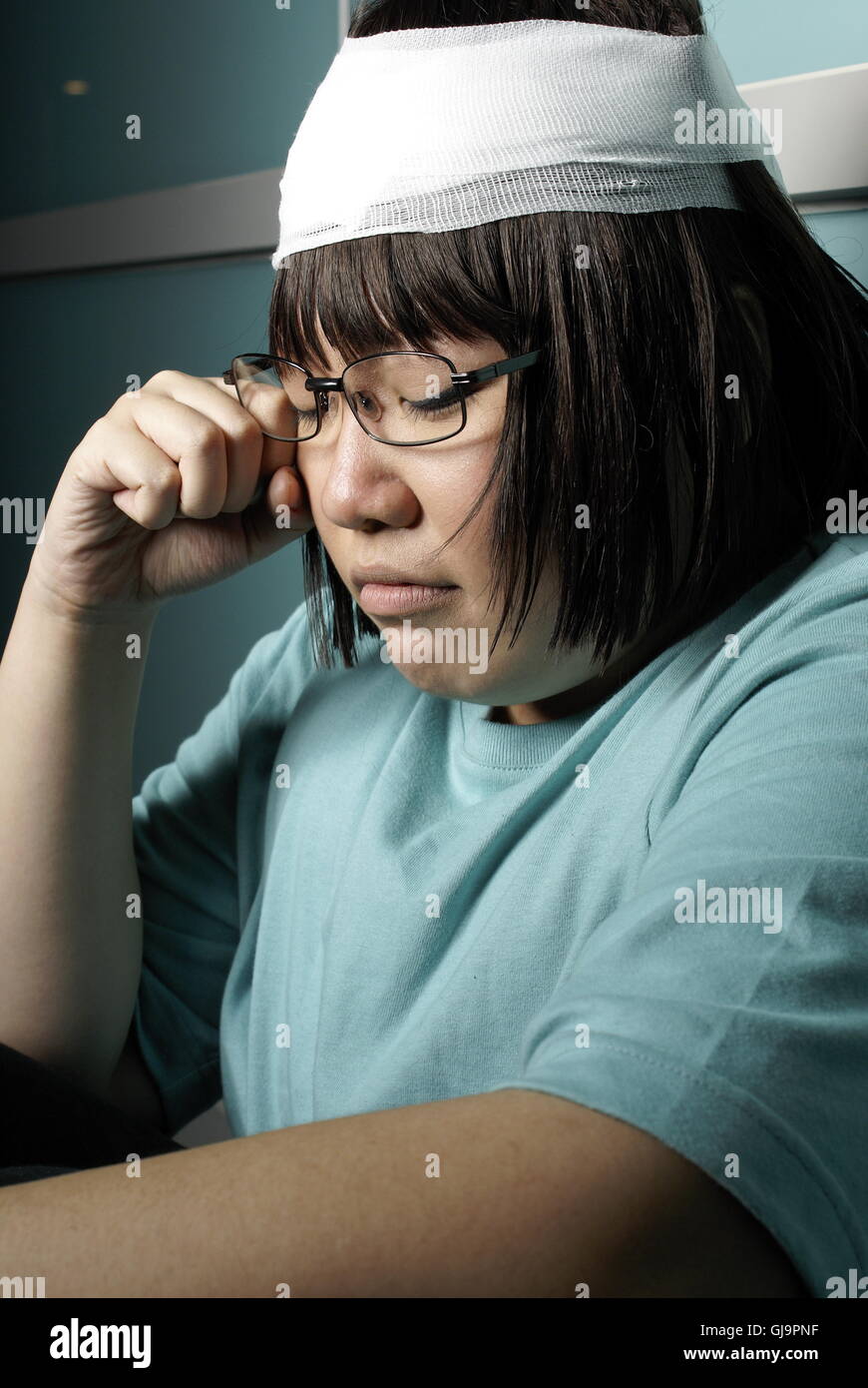 Injured and miserable teen girl unhappy crouched on floor Stock Photo ...