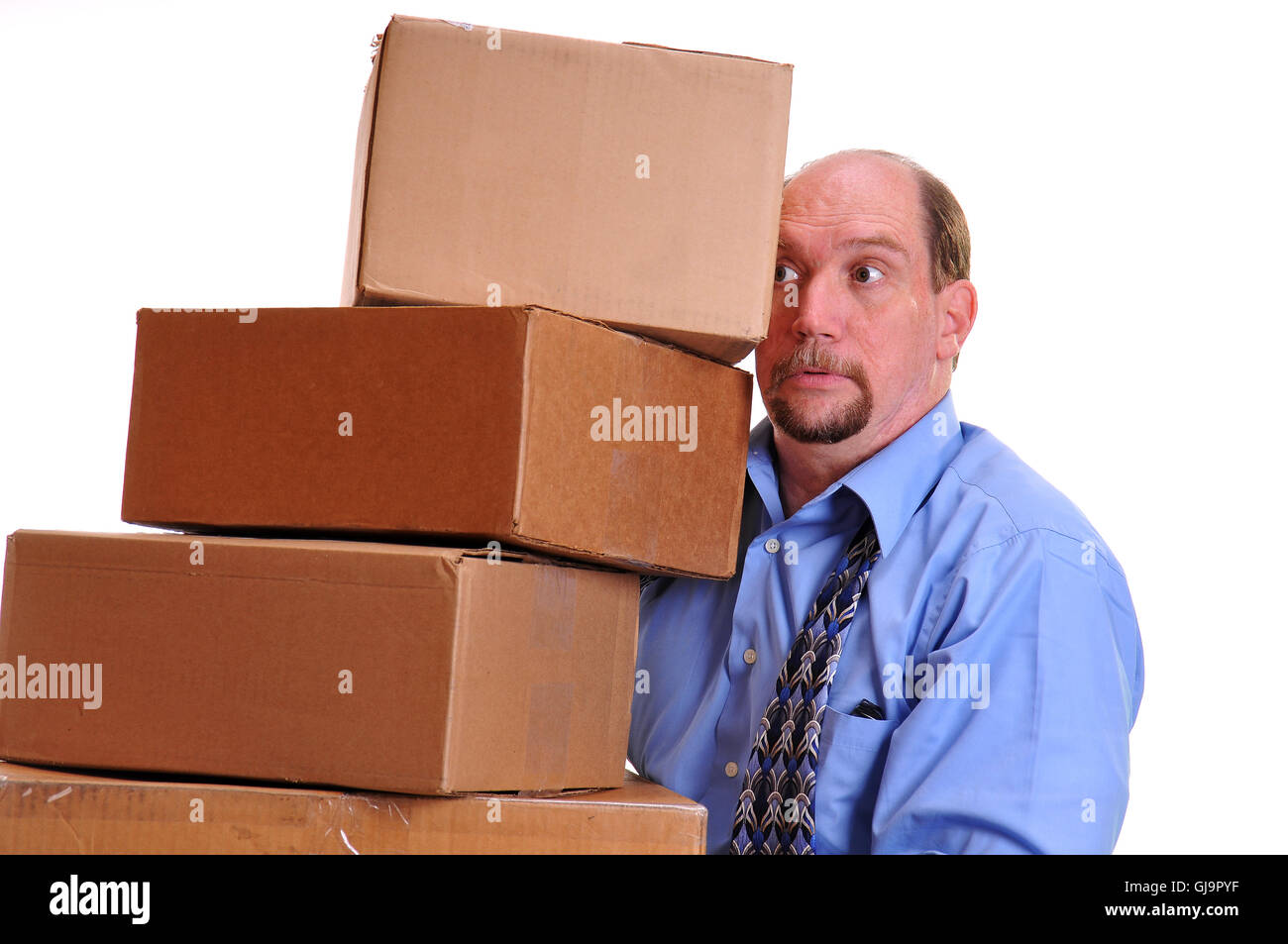Man carrying heavy boxes Stock Photo - Alamy