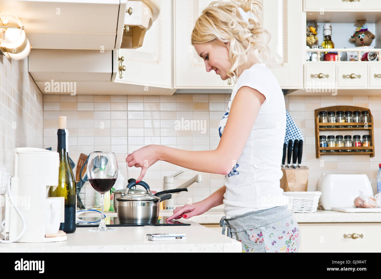 Woman working in the kitchen Stock Photo - Alamy