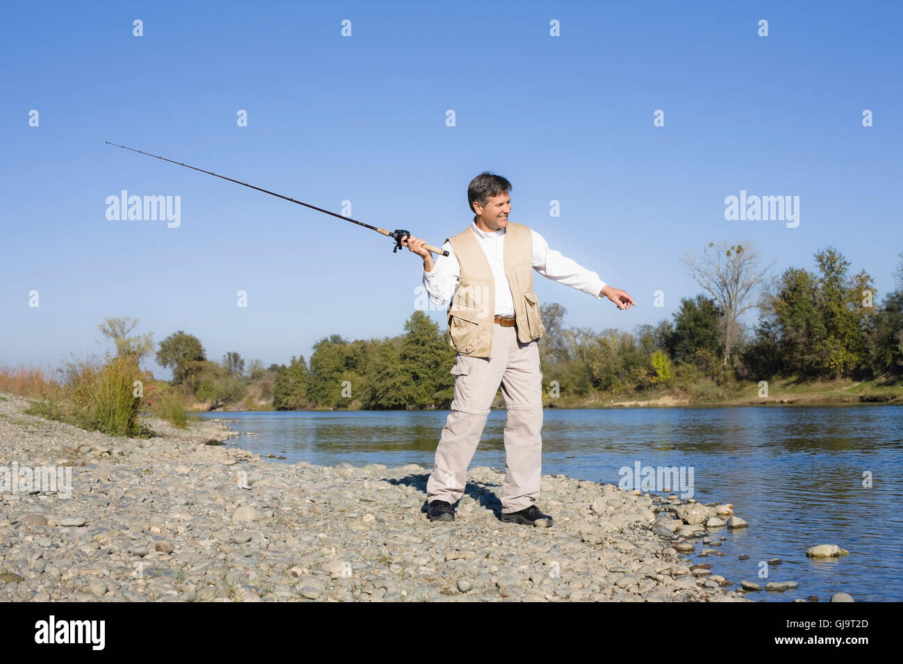Man Fishing in River Stock Photo - Alamy
