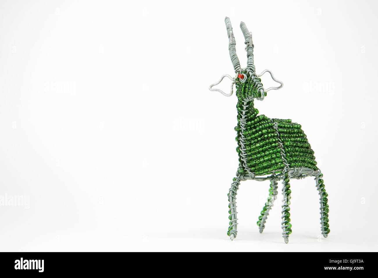 Wired and beaded African animal Craft of a Buck isolated on a wh Stock ...