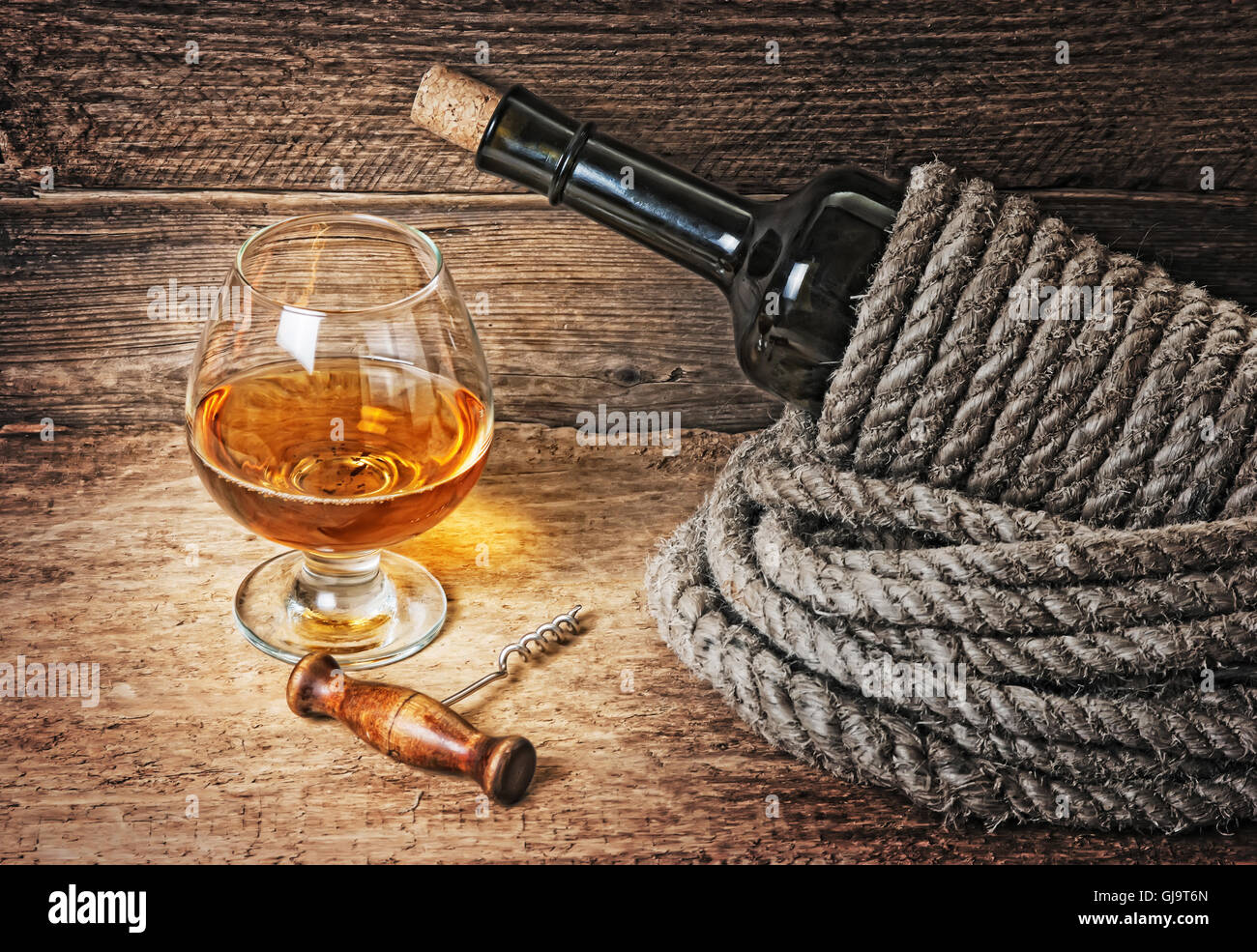 bottle of wine wrapped with rope Stock Photo - Alamy
