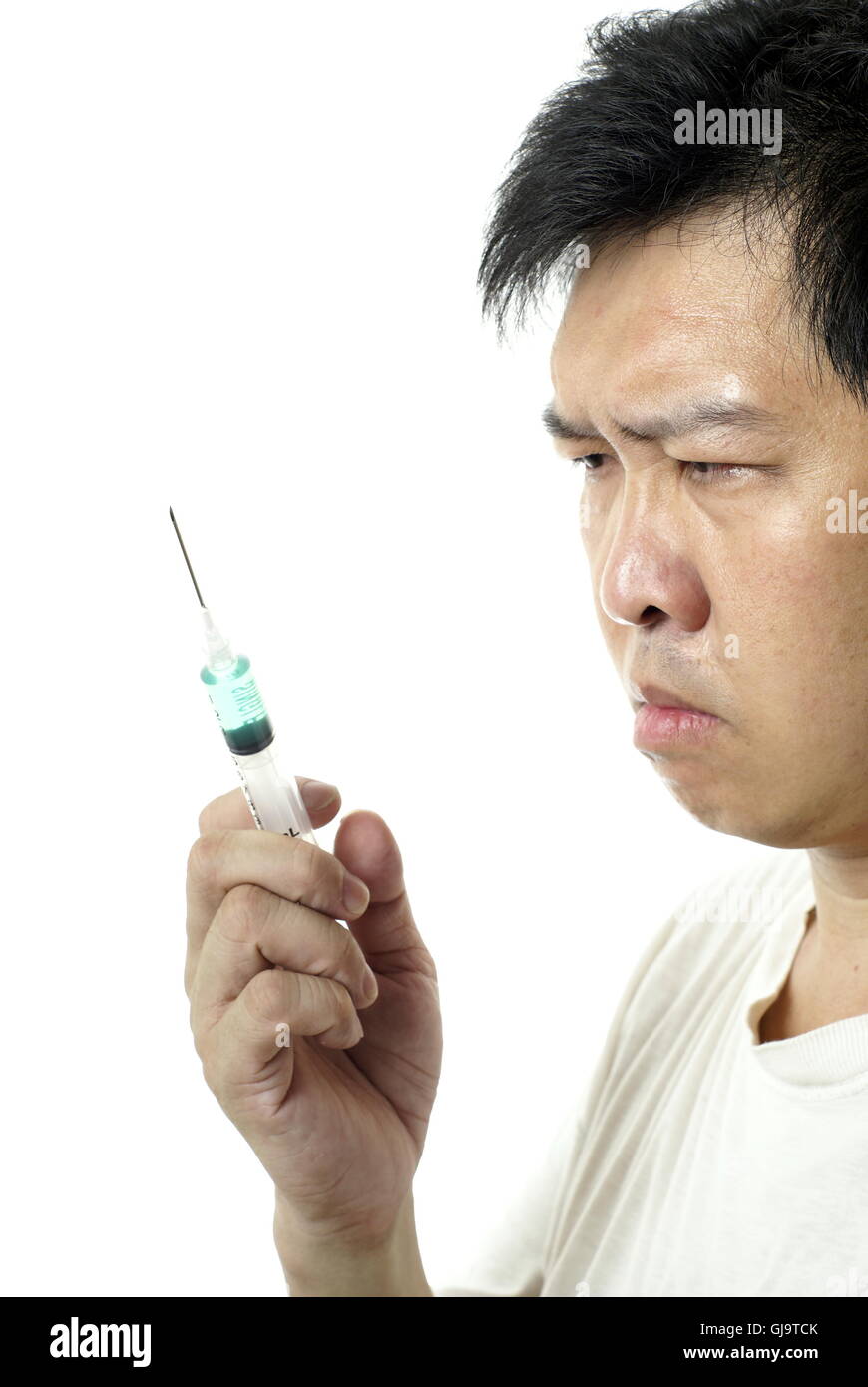 Asian man holding syringe with green liquid Stock Photo - Alamy