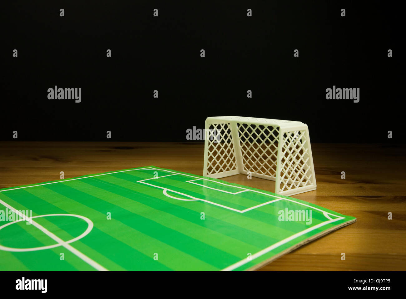 Table Top FootBall Pitch and A white Plastic Goal on A wooden Ta Stock ...