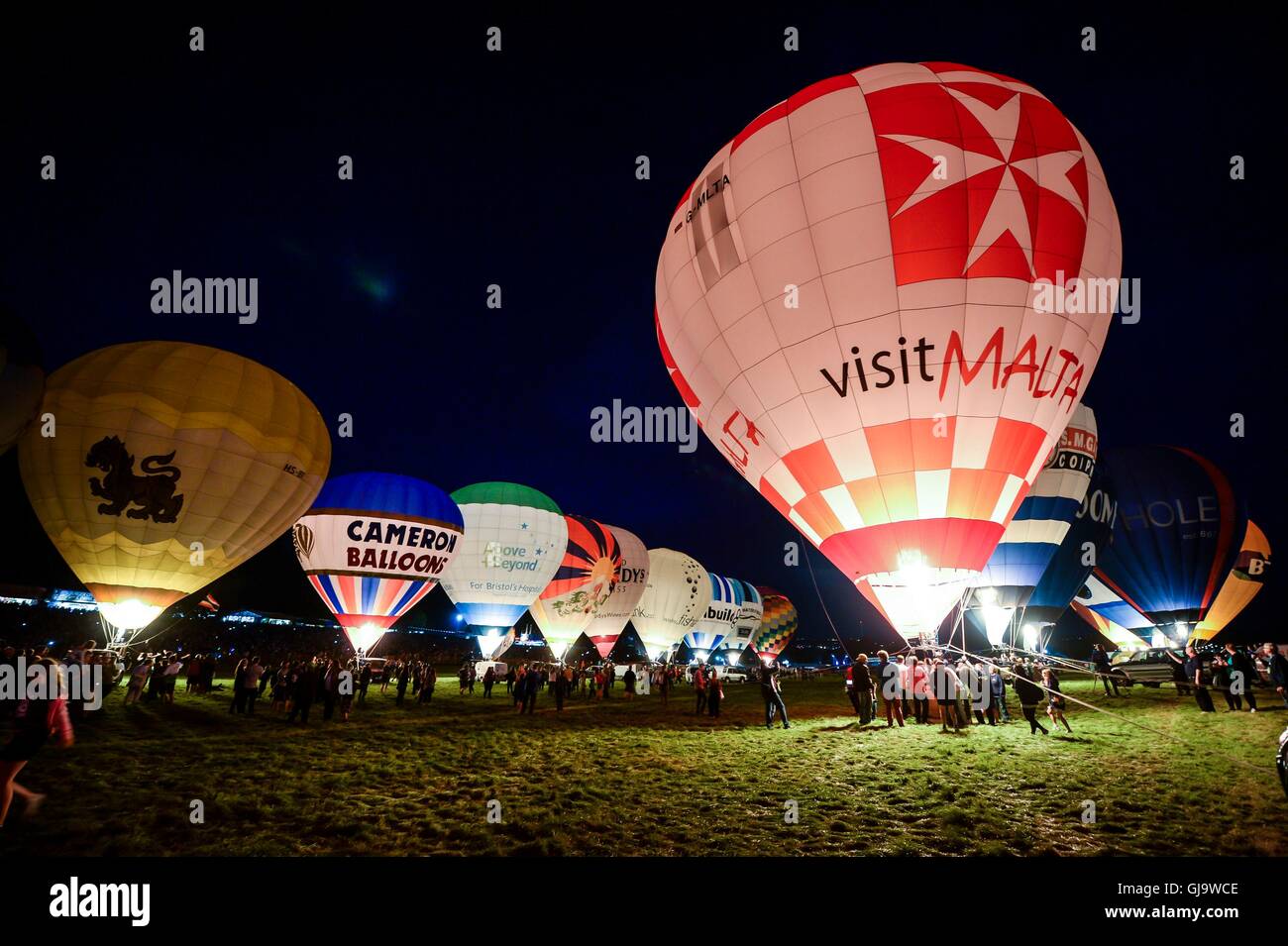 Hot air balloons light up the arena during the nightglow, where balloon ...