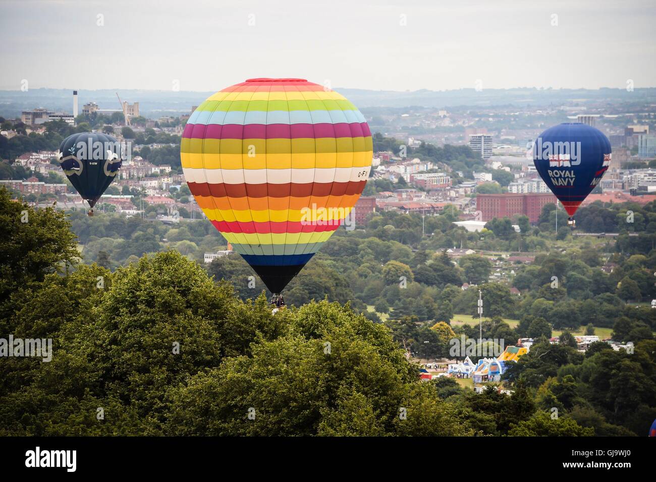A hot air balloon flies over tree tops at Ashton Court Estate after ...