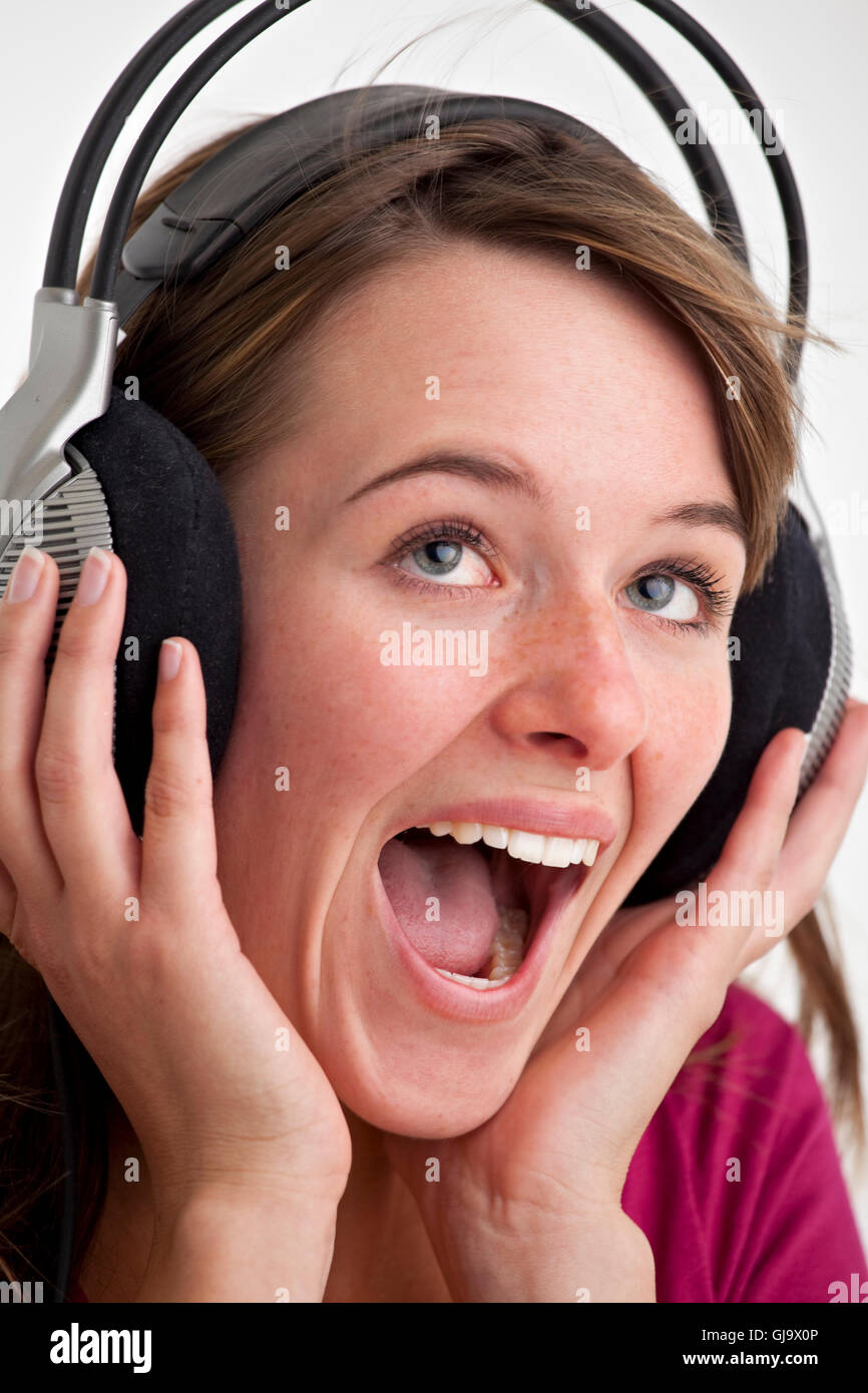 young woman screams for joy while listening to music Stock Photo - Alamy