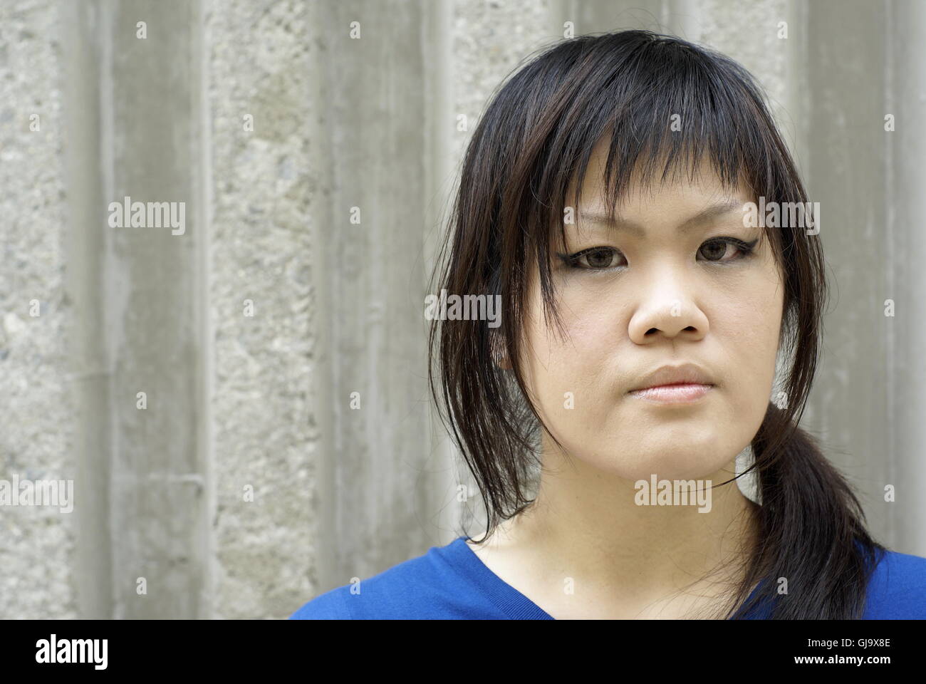 Serious looking teen lady in urban surroundings Stock Photo - Alamy