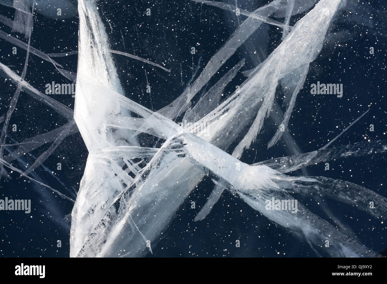 Spider web of tension cracks in thick layer of ice Stock Photo - Alamy