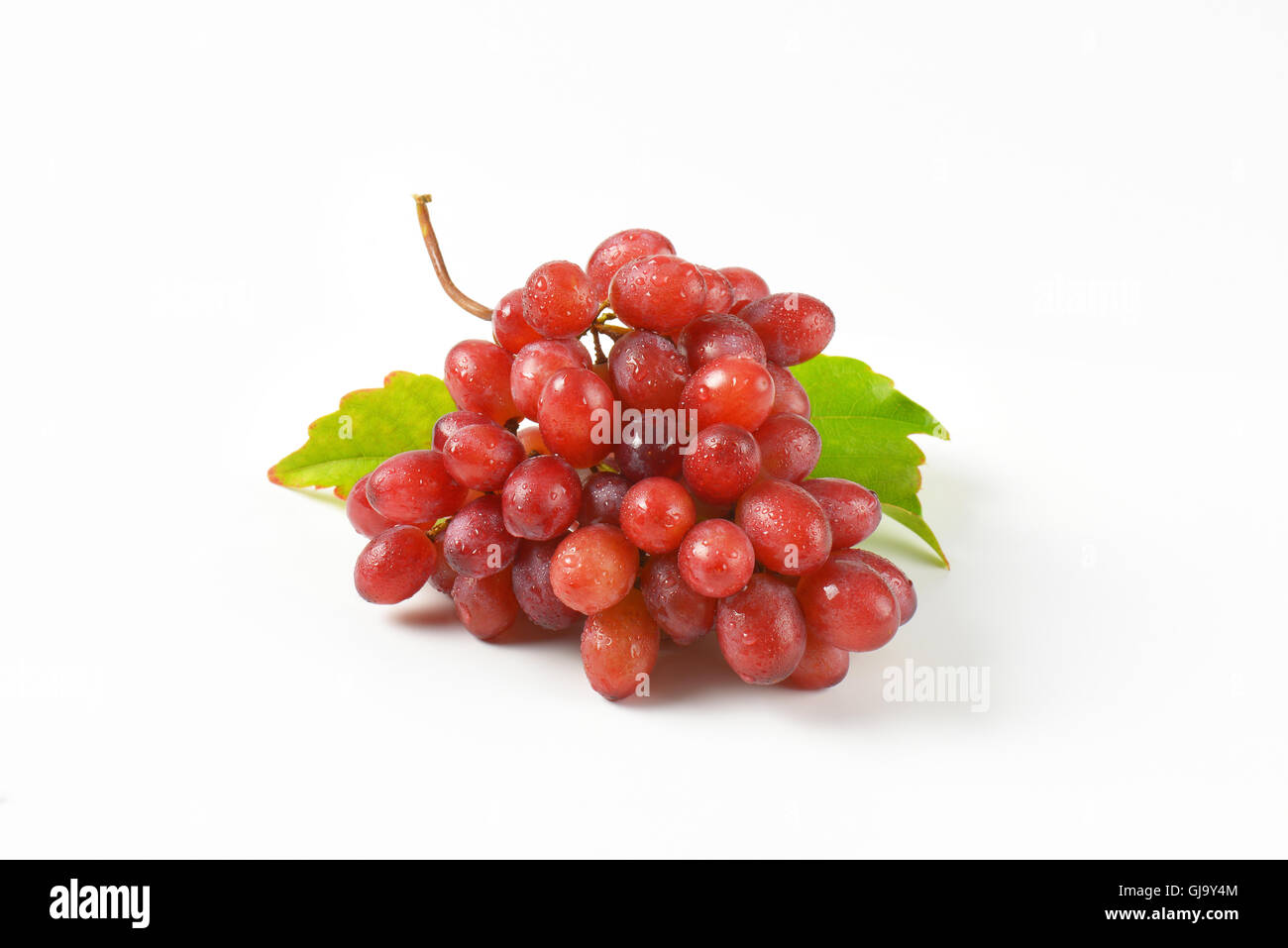 bunch of washed red grapes on white background Stock Photo - Alamy