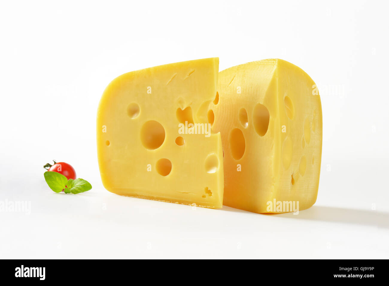 two wedges of fresh cheese on white background Stock Photo - Alamy