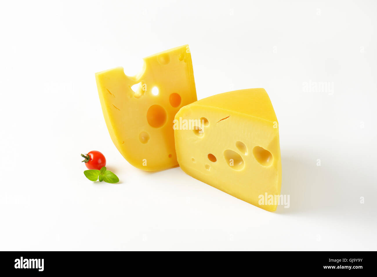 two wedges of fresh cheese on white background Stock Photo - Alamy