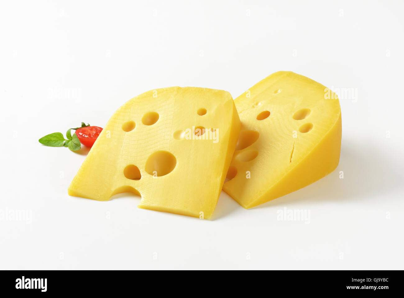 two wedges of fresh cheese on white background Stock Photo - Alamy