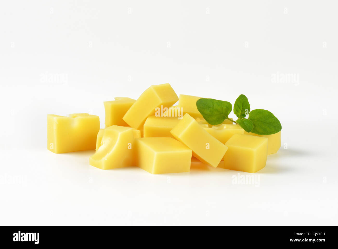 handful of cheese cubes on white background Stock Photo - Alamy
