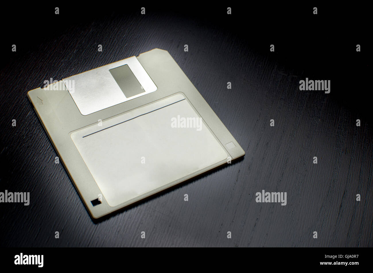 grey floppy disk empty label with black wooden desk background Stock ...