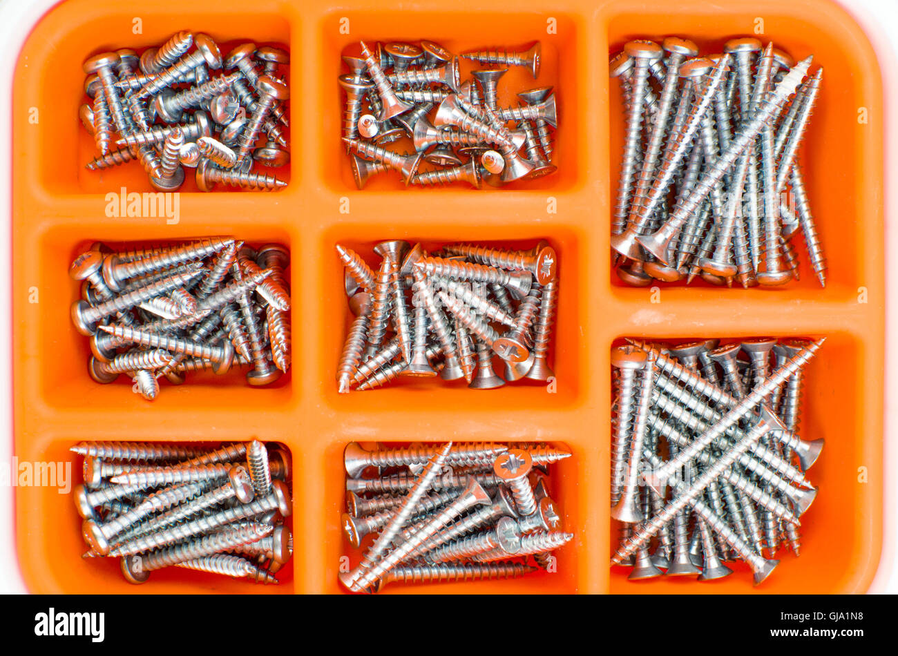 orange container with screws Stock Photo - Alamy