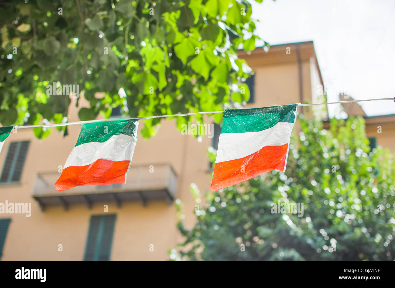 small Italian flags hanging by a thread tricolore Stock Photo - Alamy