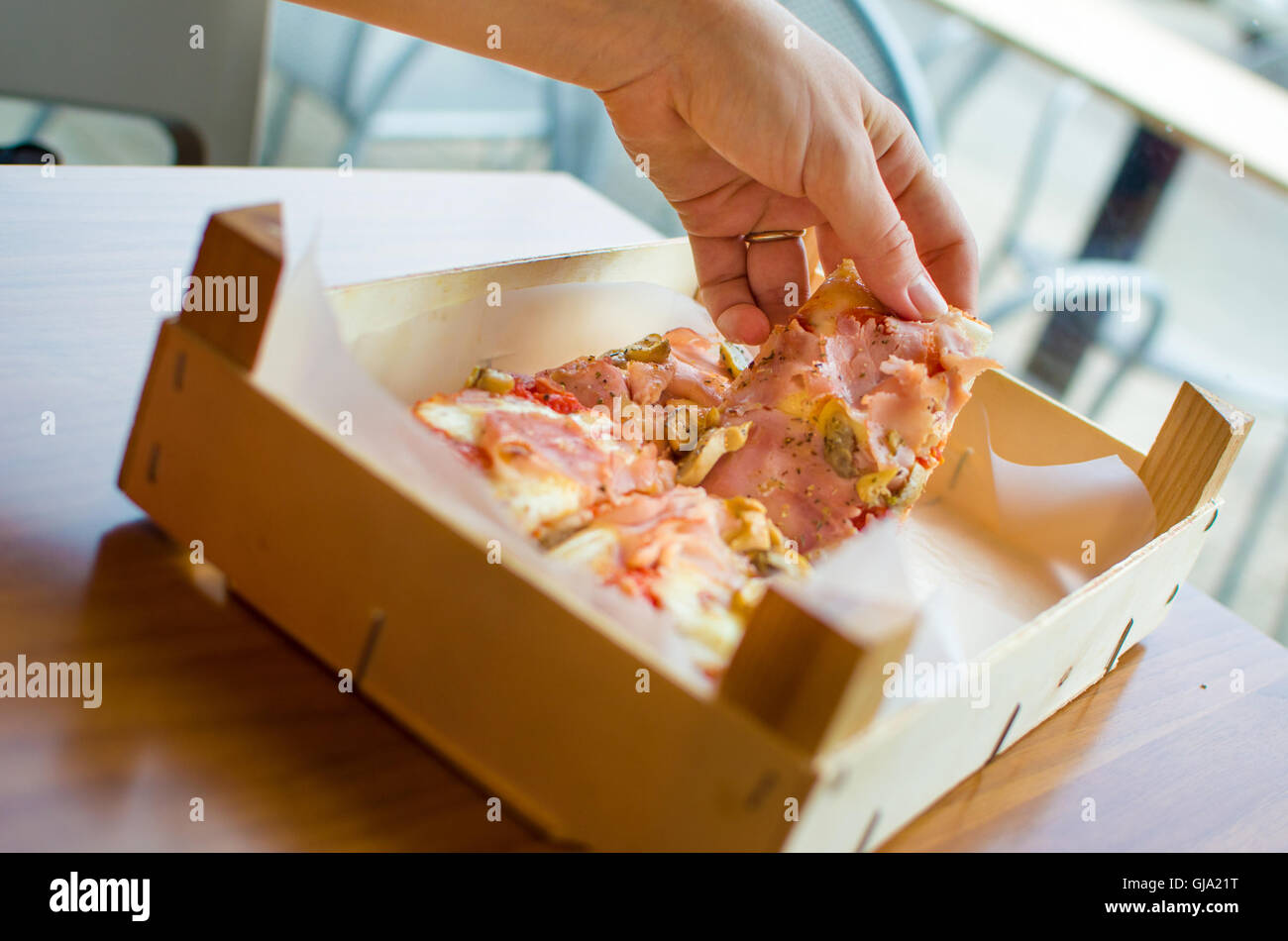 Hand take pizza hi-res stock photography and images - Alamy