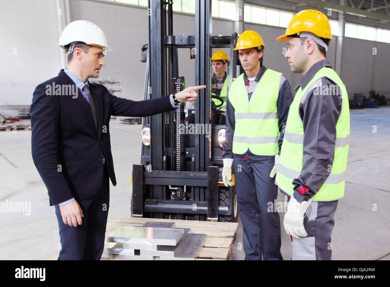 Workers and loader with aluminium billets at CNC machine shop Stock ...