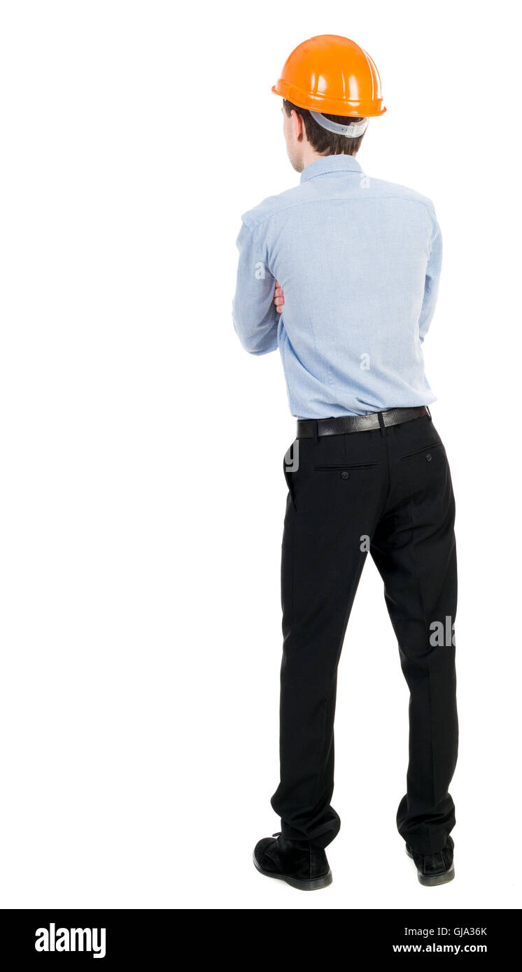 Backview of an engineer in construction helmet stands Stock Photo - Alamy