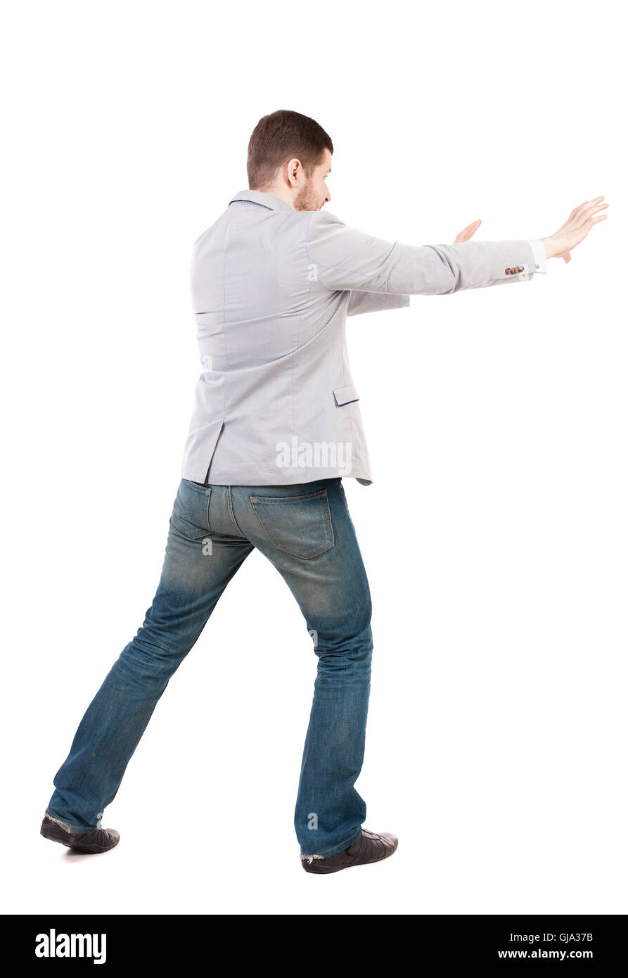 back view of business man pushes wall Stock Photo - Alamy