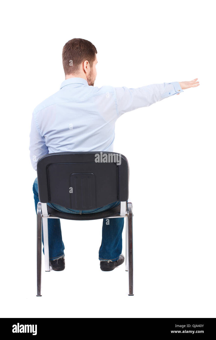 Man sitting on chair back pointing hi-res stock photography and images ...