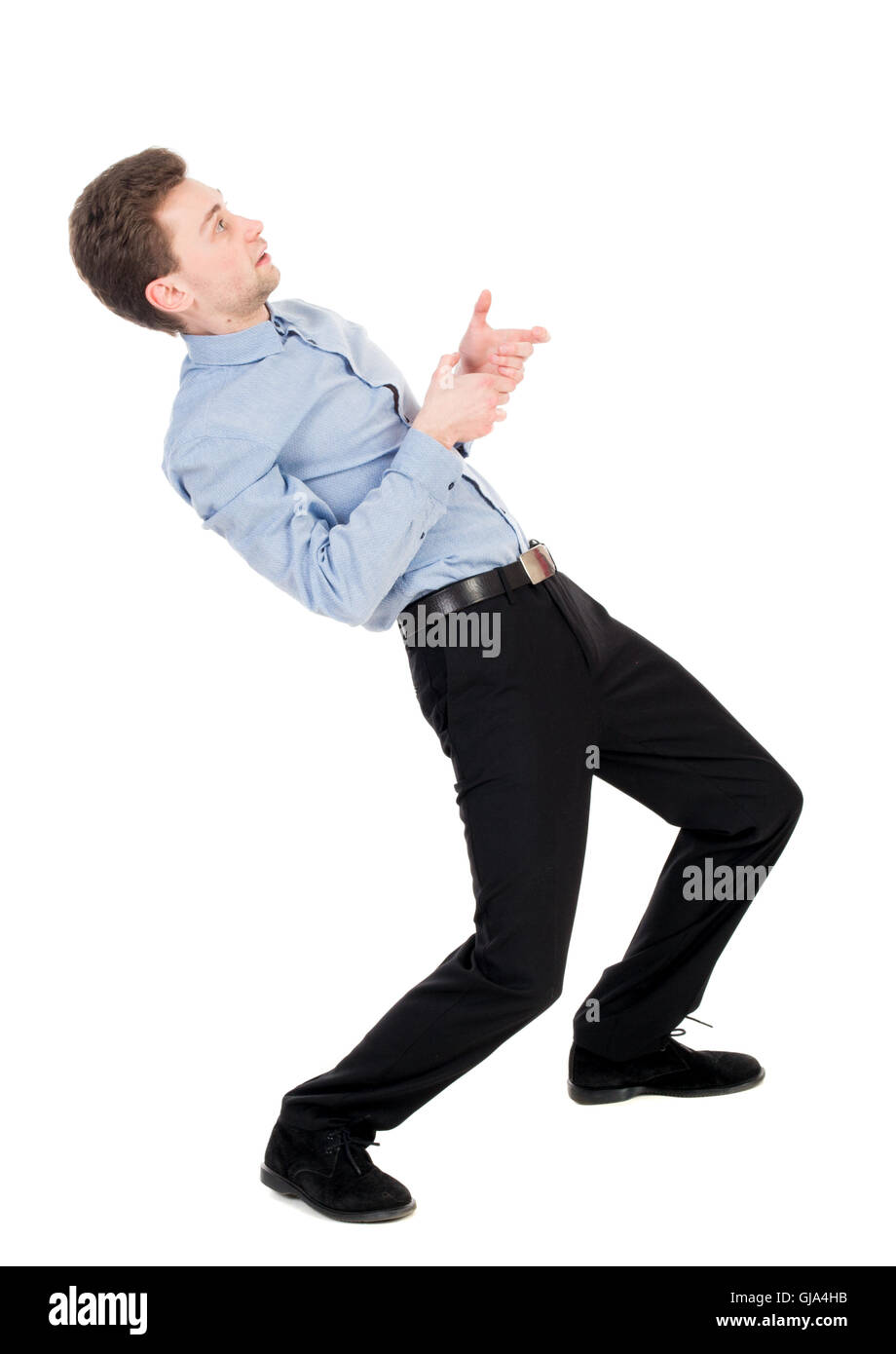 back view of standing man pulling a rope from the top or cling t Stock ...