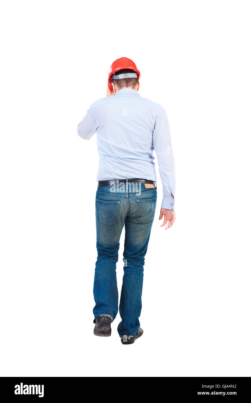 Back view of walking engineer in helmet Stock Photo - Alamy